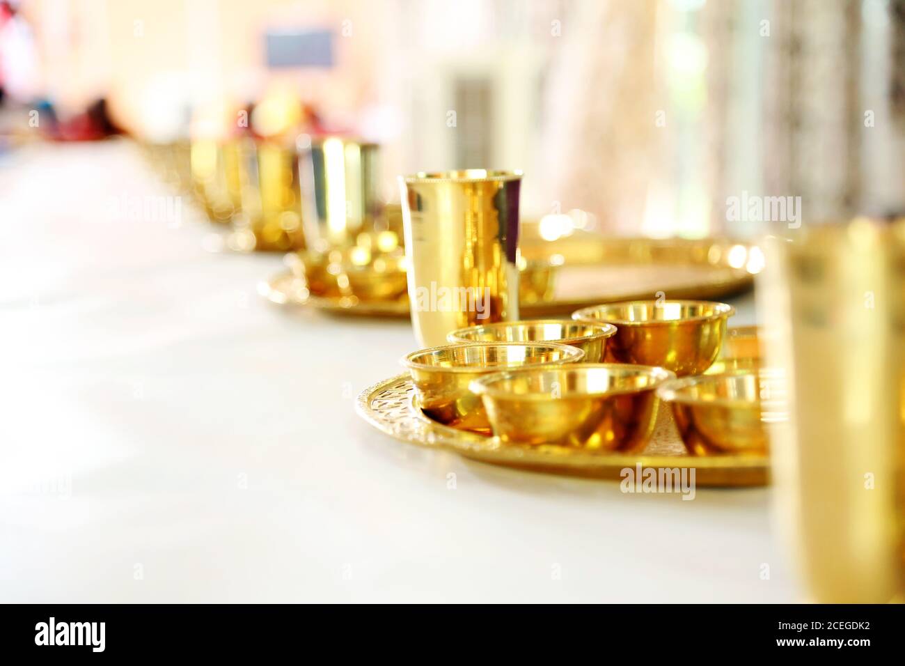 Closeup shot of golden dinner set for the wedding and reception ...