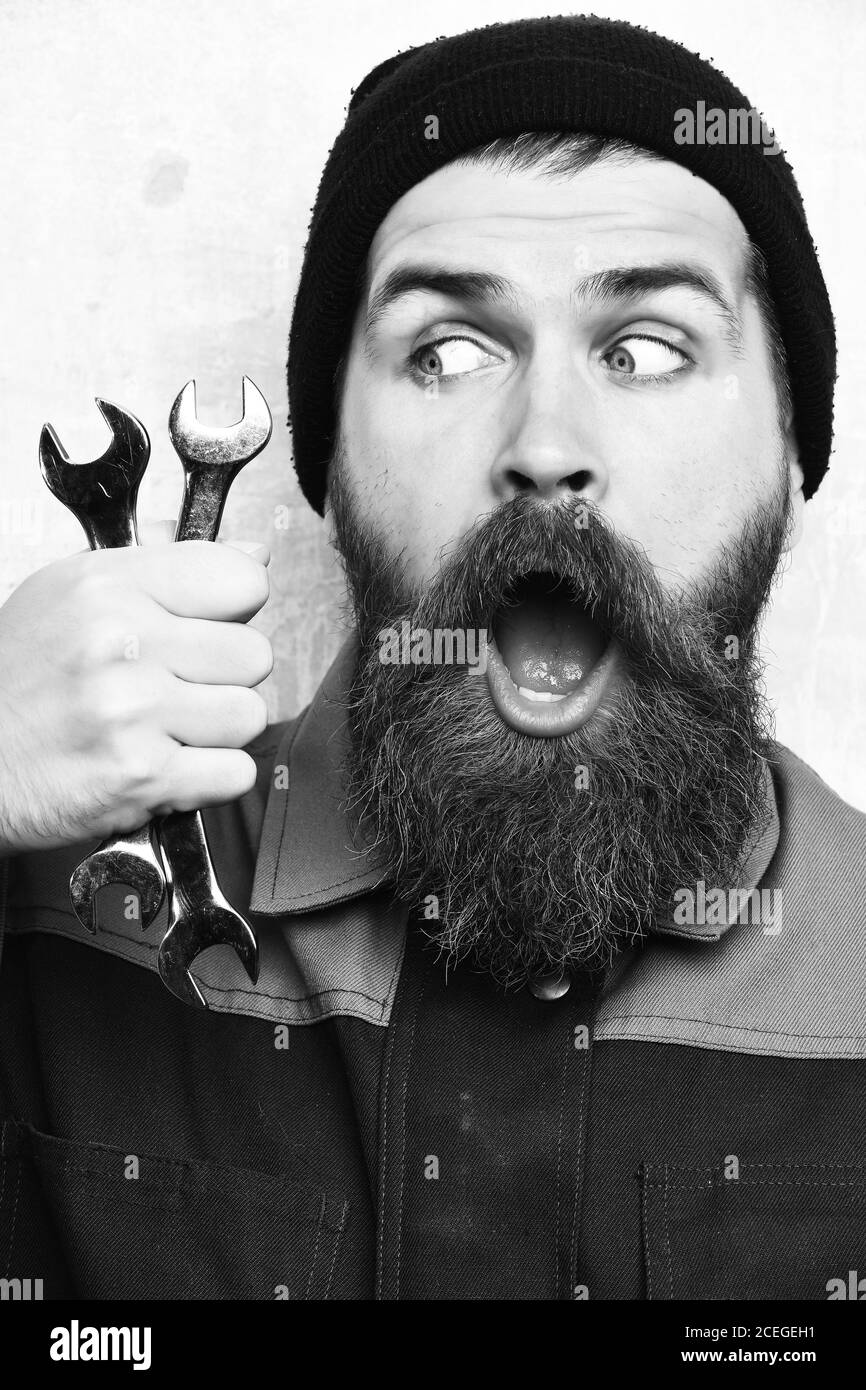 Bearded man, long beard. Brutal caucasian mechanic, surprised unshaven ...