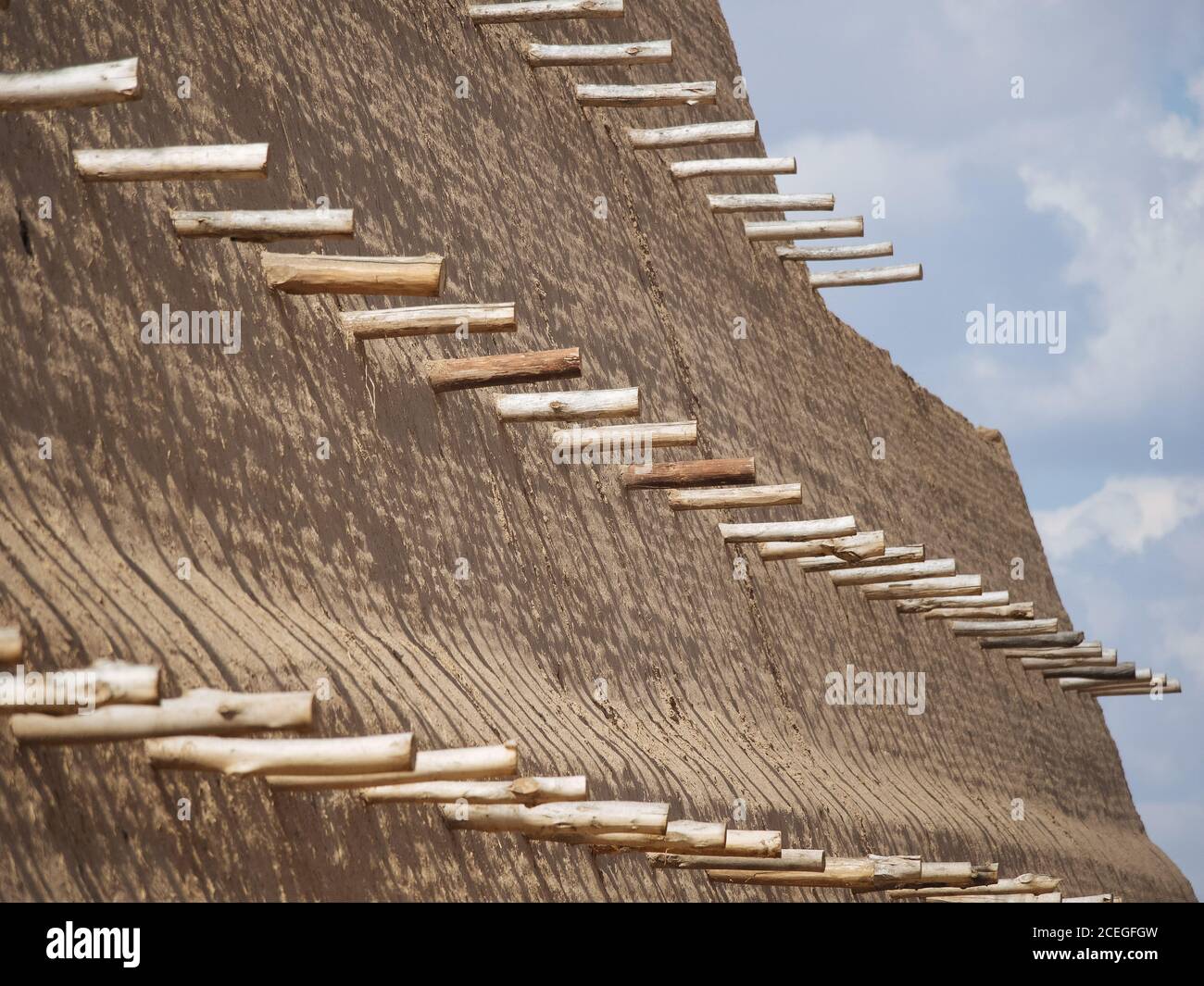 From below shot of solid huge brick wall of fortress with wooden balks ...
