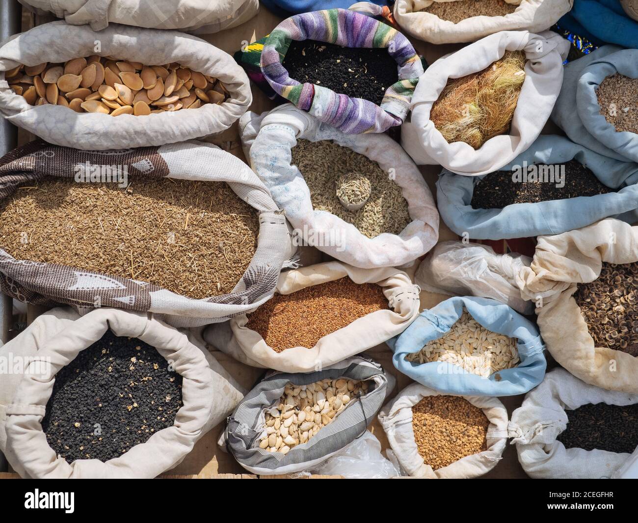 Top view fabric bags filled various grains aromatic spices condiments ...