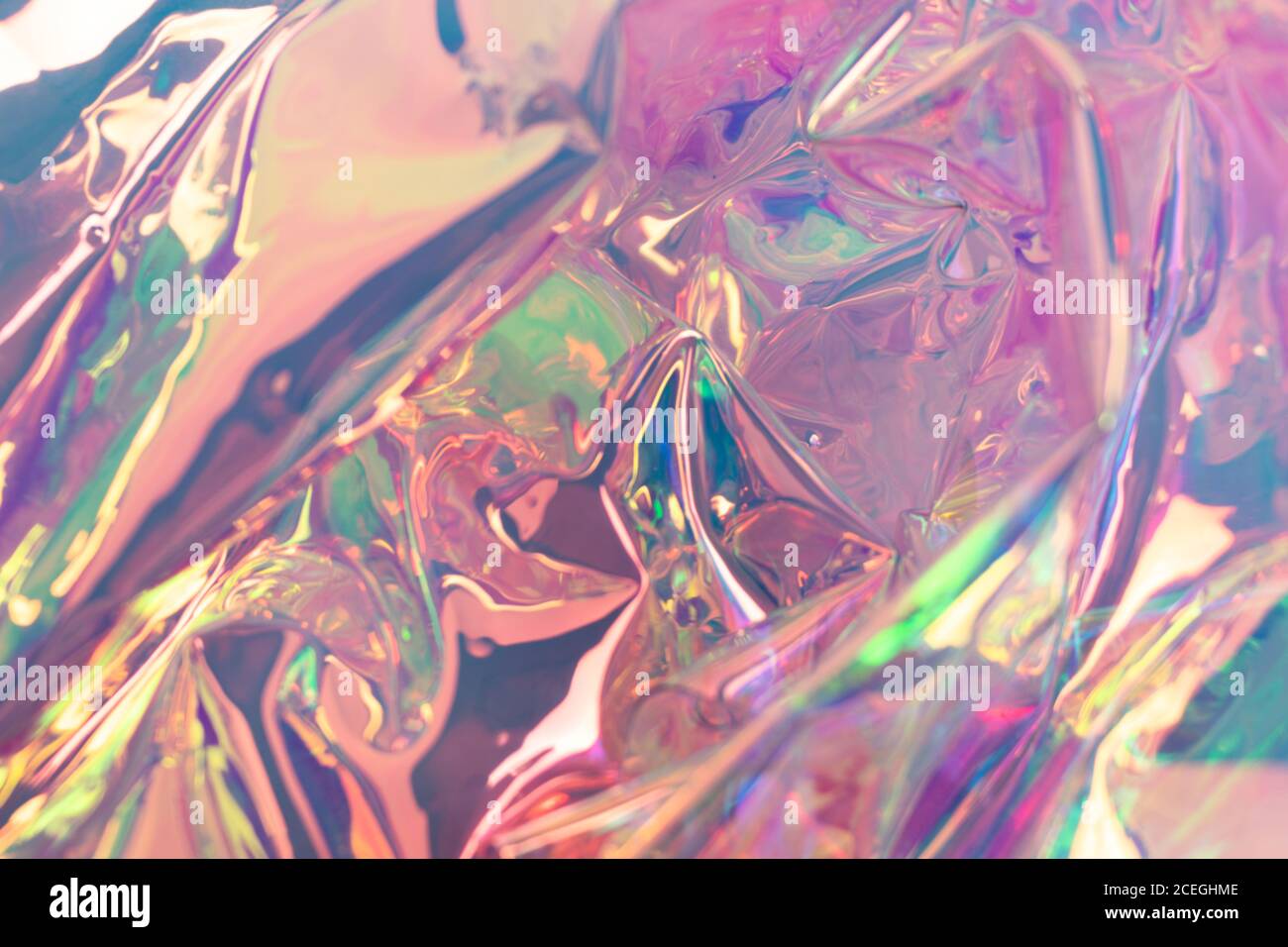 Pink iridescent defocused holographic background. Wrinkled foil texture ...