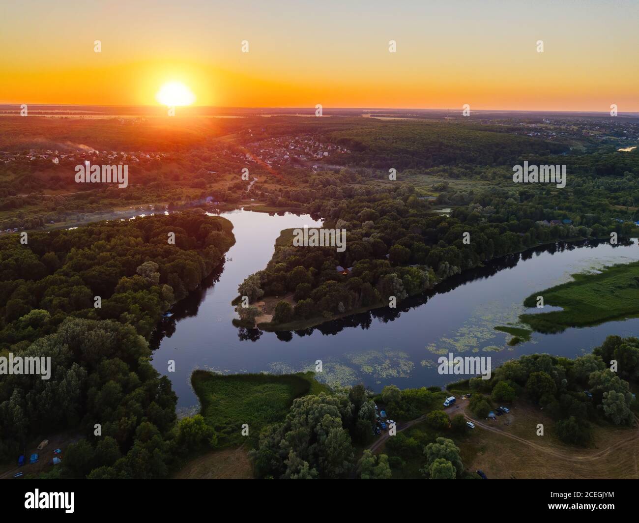 Sunset above the river in natural rural landscape Stock Photo - Alamy