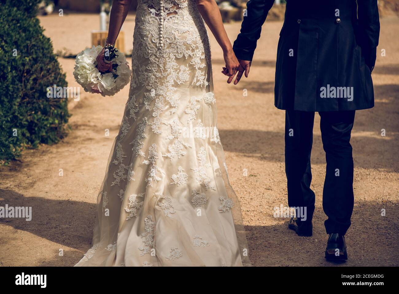 Married couple in wedding clothes holding hands Stock Photo - Alamy