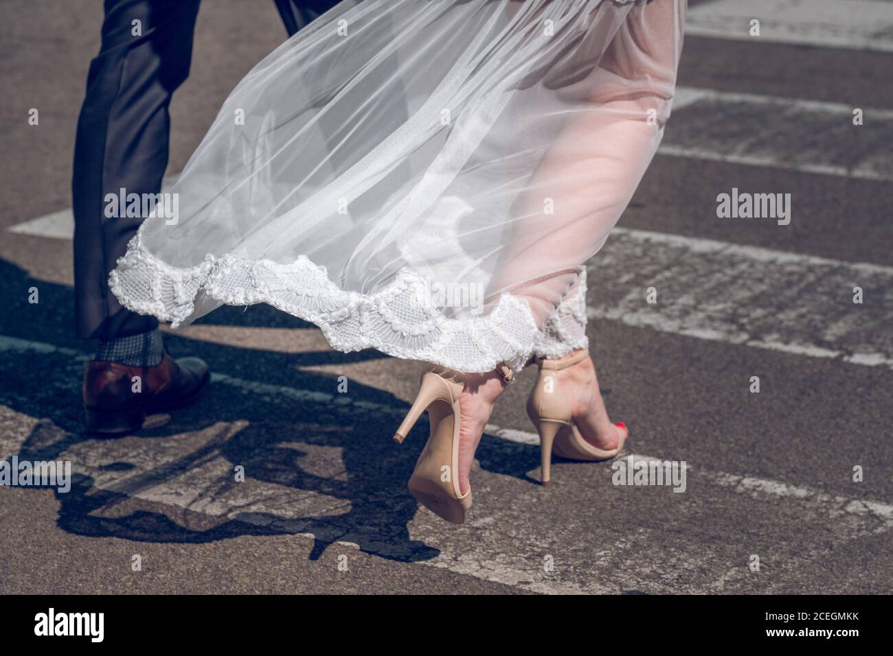 Married couple in wedding clothes holding hands Stock Photo - Alamy