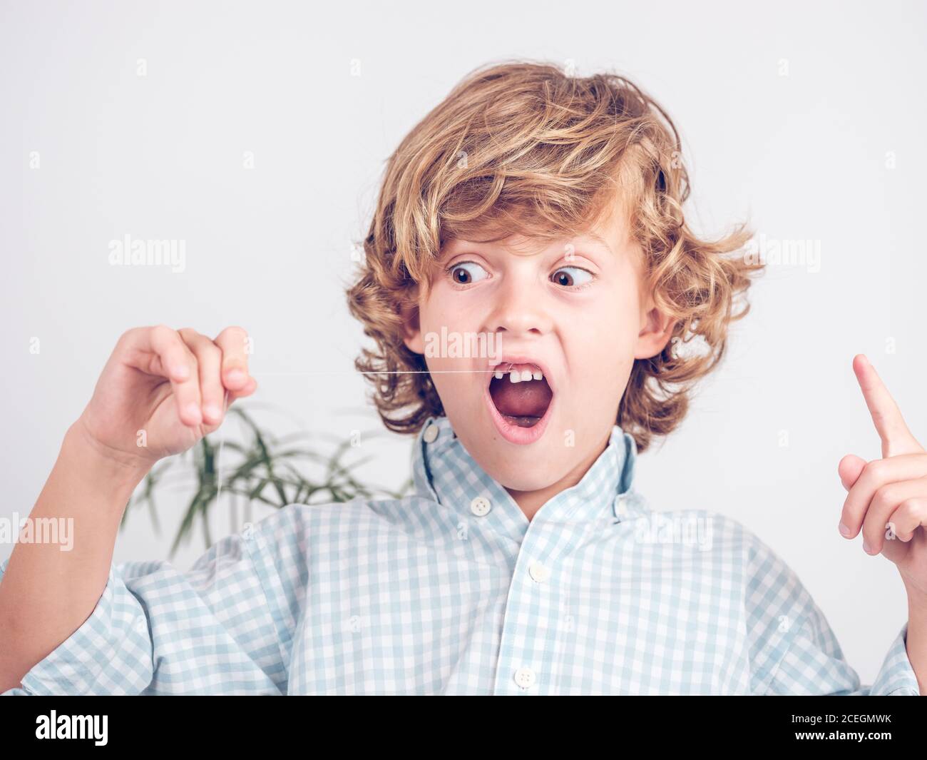 Little adorable boy making scared grimace and pulling tooth out with ...