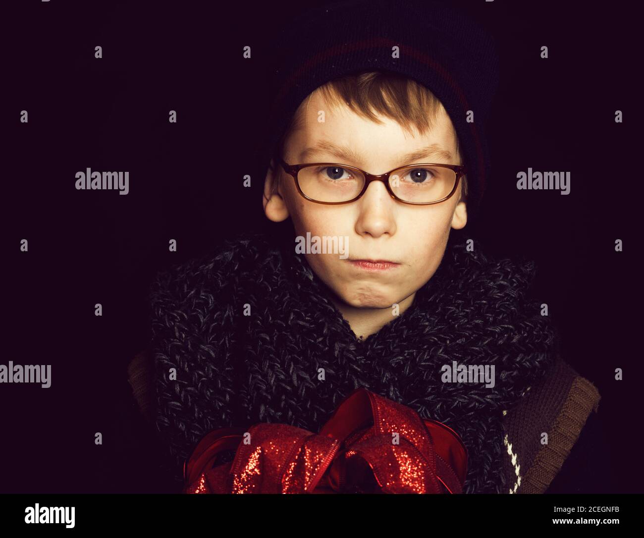 small boy or cute nerd kid in glasses, hat and fashionable knitted ...