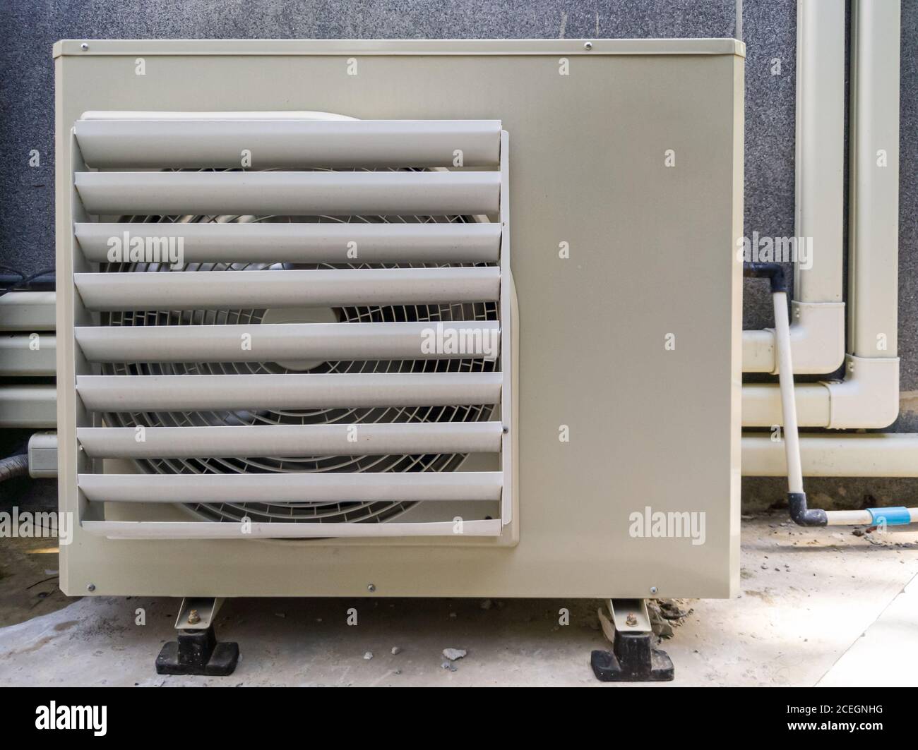 Modern compressor unit of the air conditioner system near the building ...