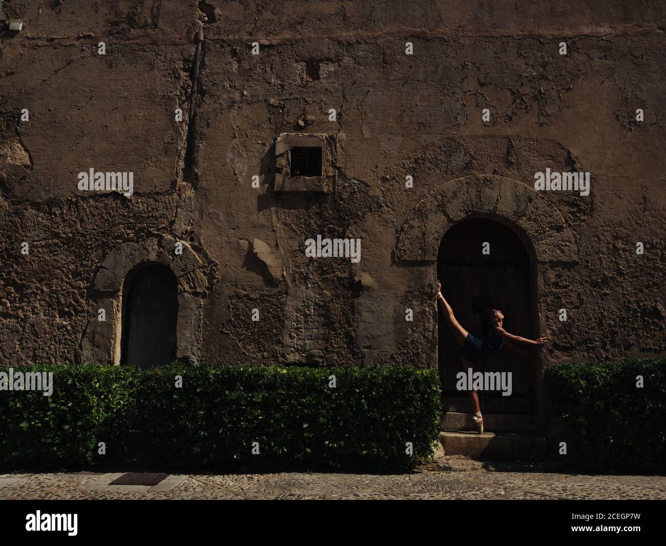 Side view of pretty ballet dancer Woman standing and posing at vintage ...