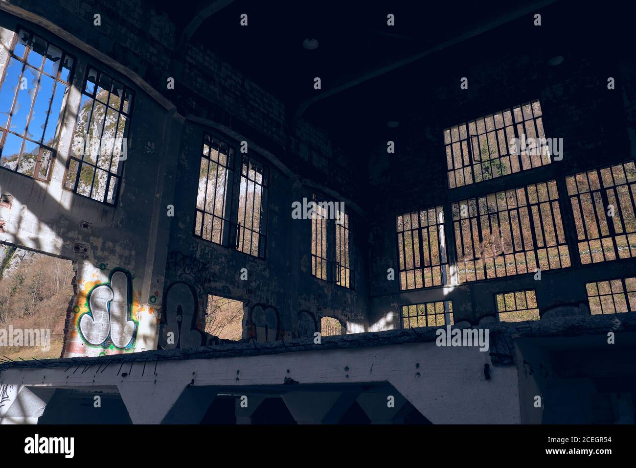 Inside of deserted building without windows with graffiti on walls near ...