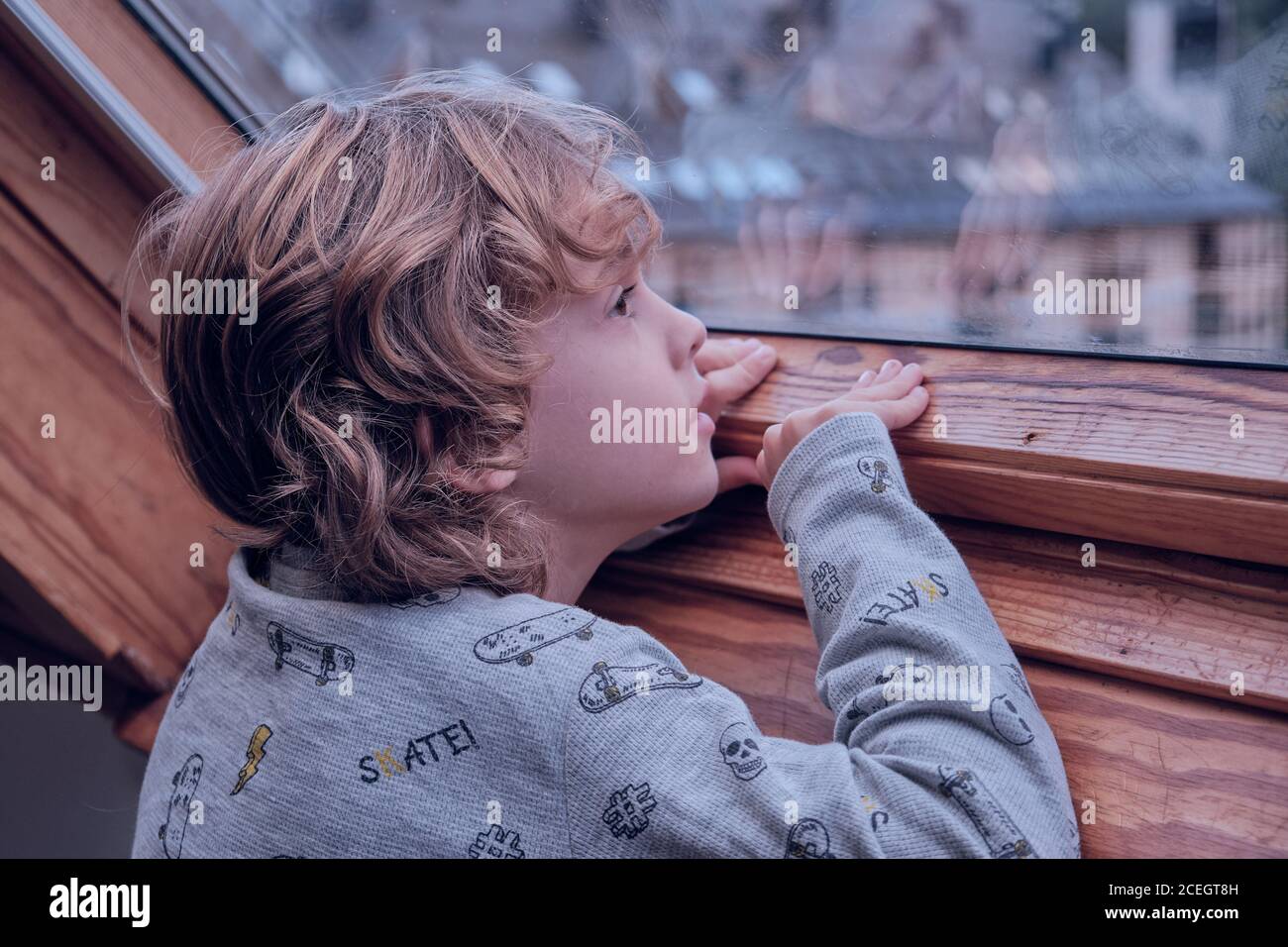 Boy looking through window hi-res stock photography and images - Alamy