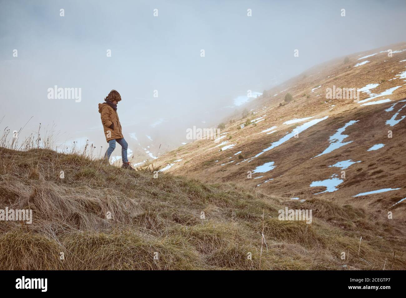 anonymous kid standing on hill top Stock Photo - Alamy