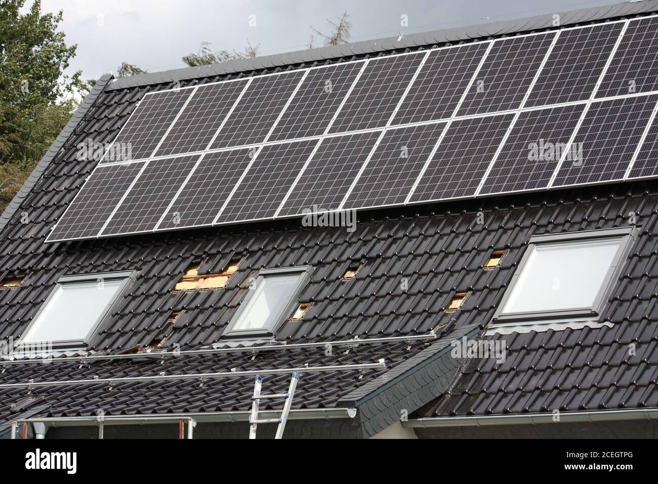Black roof with installed solar panels Stock Photo - Alamy