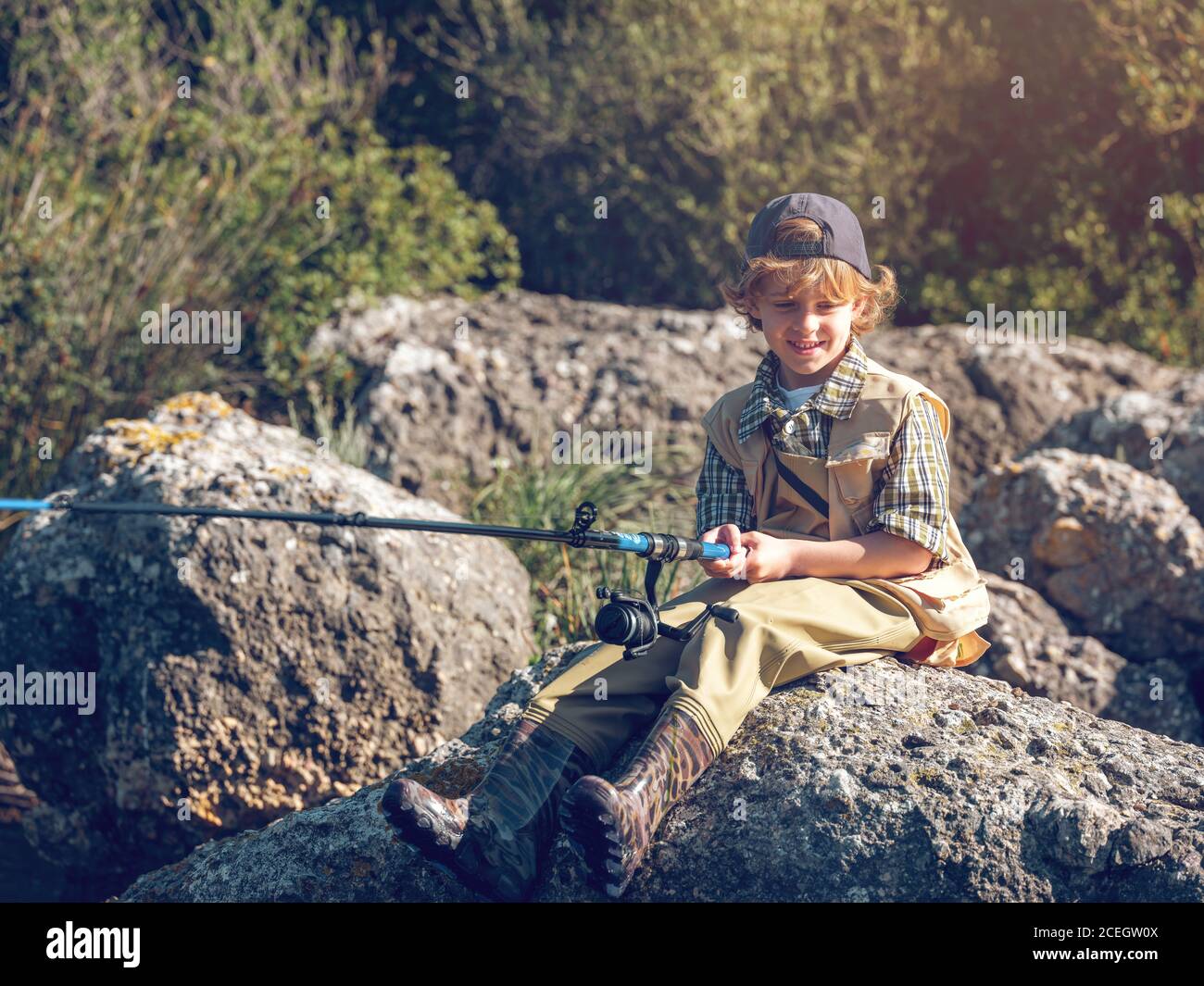 Boy sitting on stone hi-res stock photography and images - Alamy