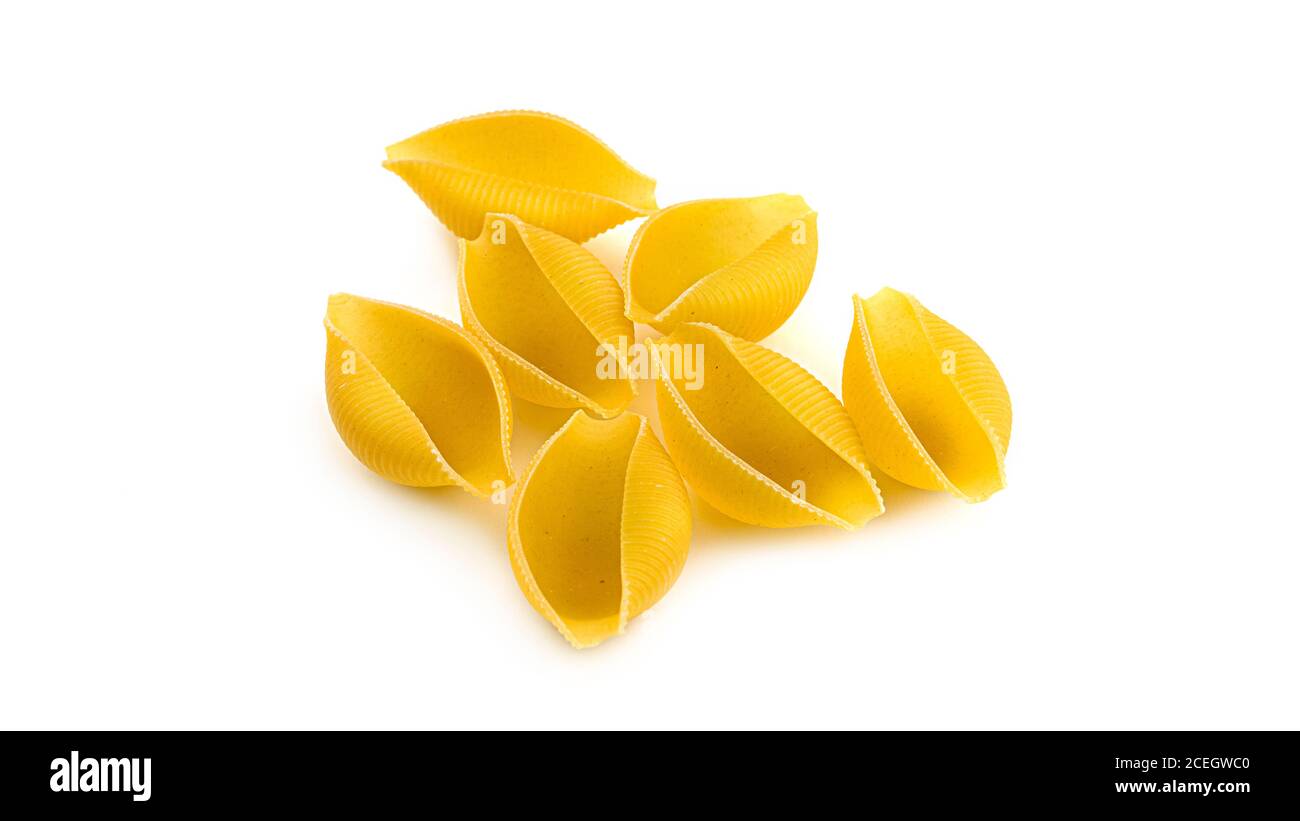Uncooked shell pasta on white background Stock Photo - Alamy