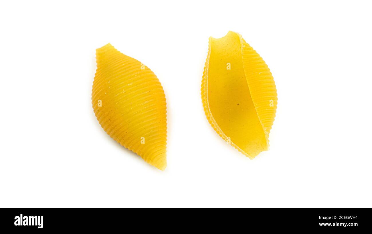 Uncooked shell pasta on white background Stock Photo - Alamy