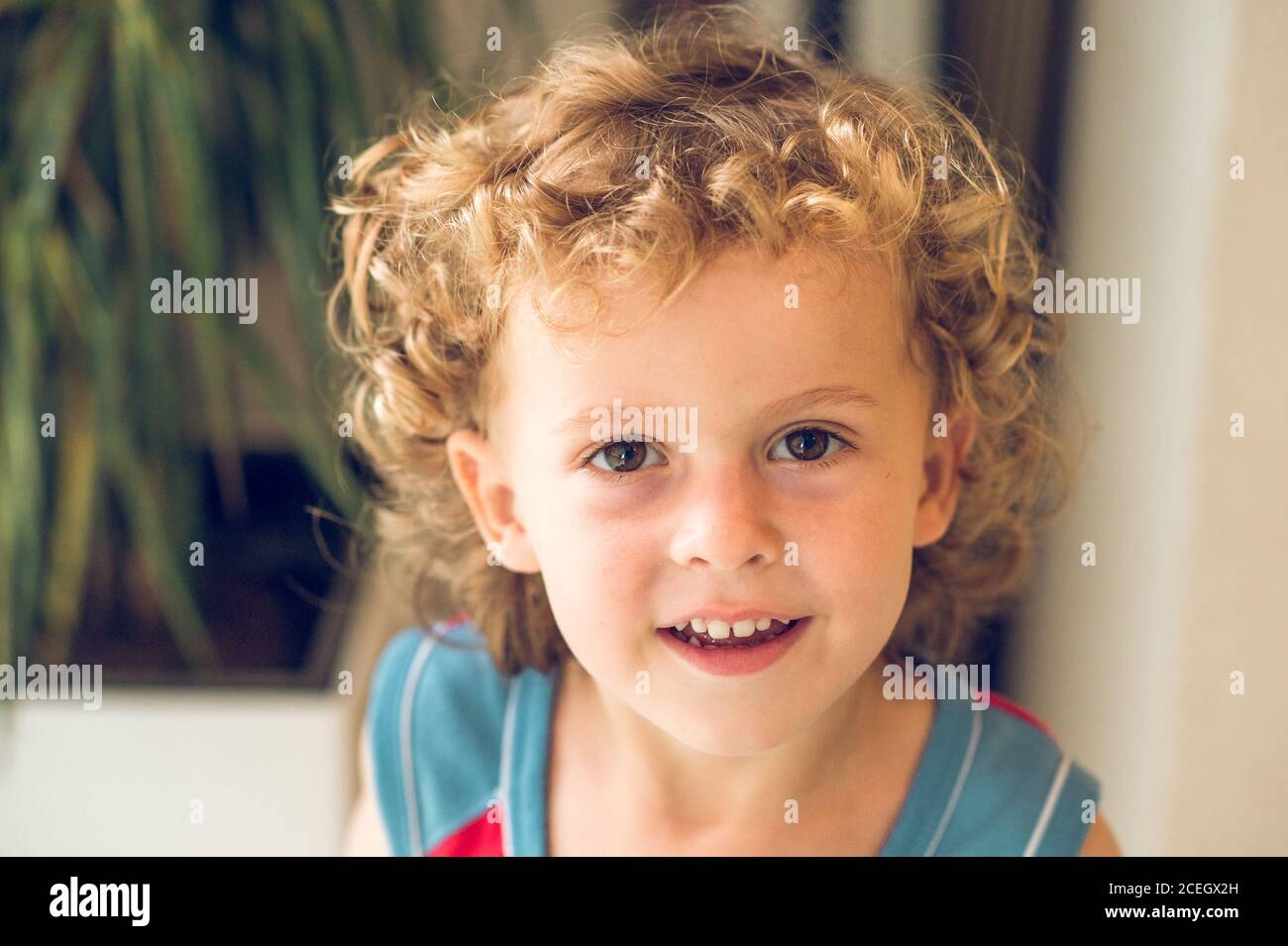 Smiling boy at the window Stock Photo - Alamy