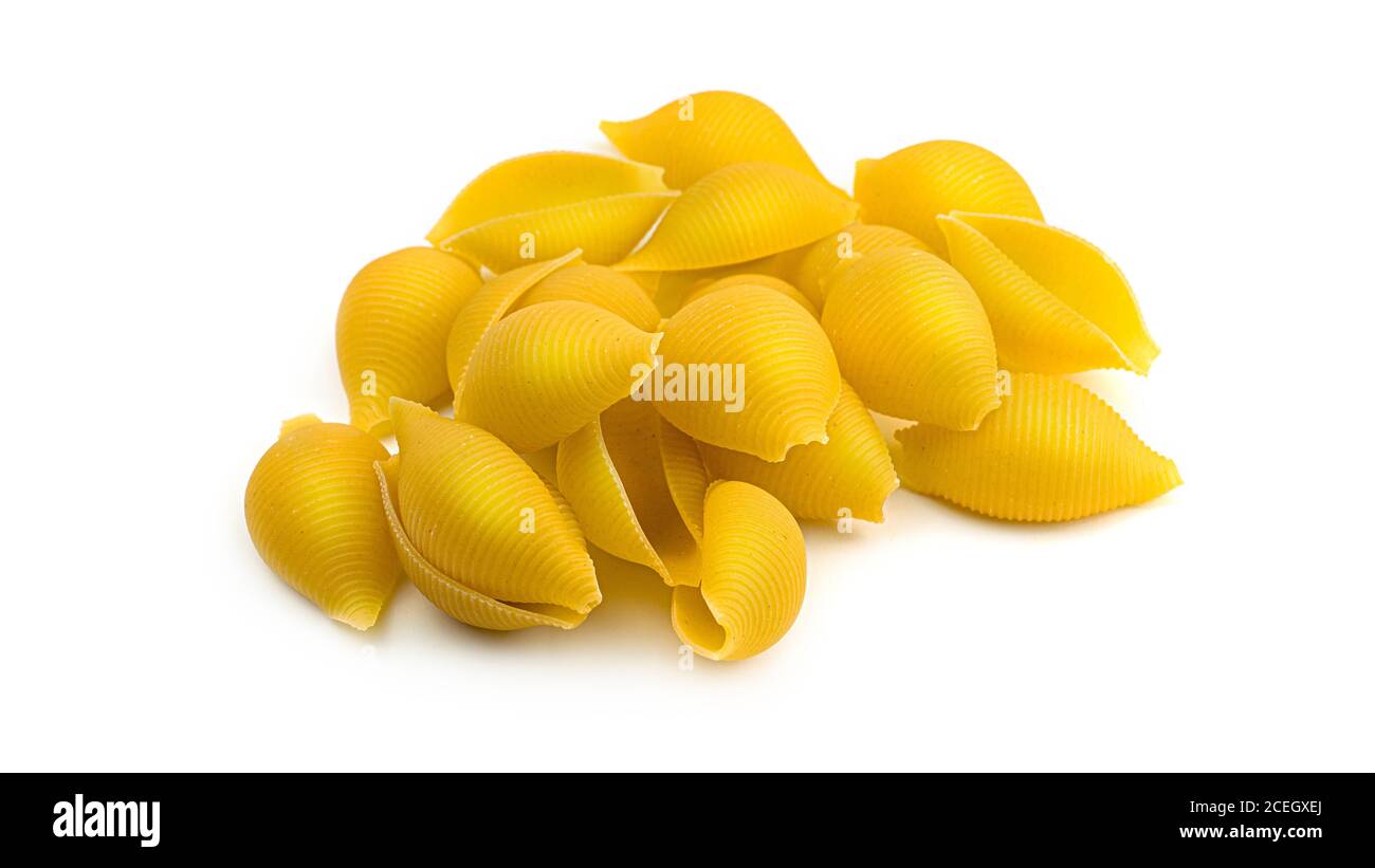 Uncooked shell pasta on white background Stock Photo - Alamy
