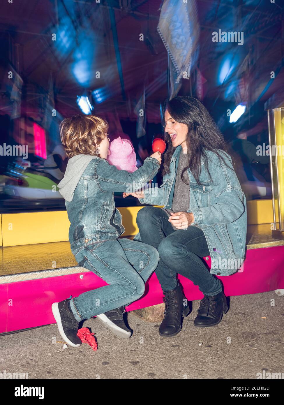 Mother and son with snacks on funfair Stock Photo - Alamy