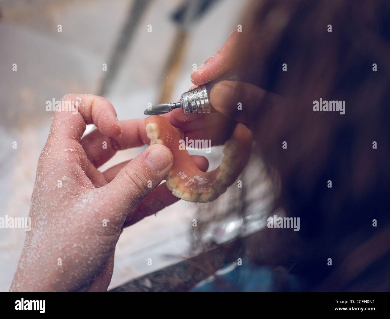 Dental technician polishing teeth Stock Photo - Alamy
