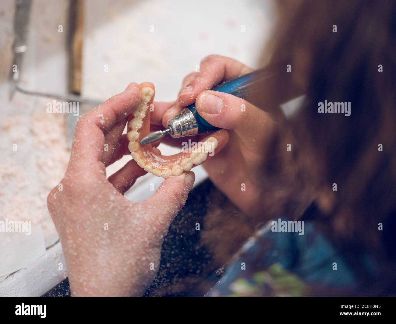 Dental technician polishing teeth Stock Photo - Alamy