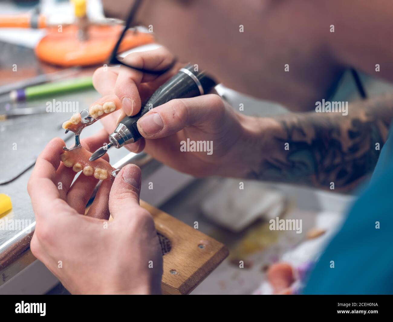Dental technician polishing teeth Stock Photo - Alamy