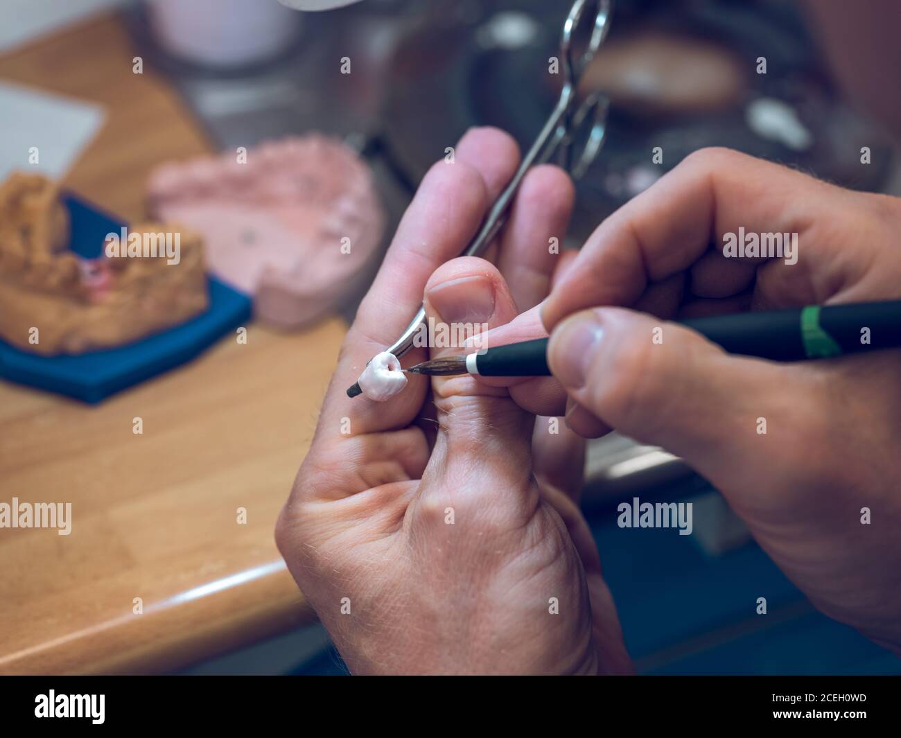 Crop hands carving tooth Stock Photo - Alamy