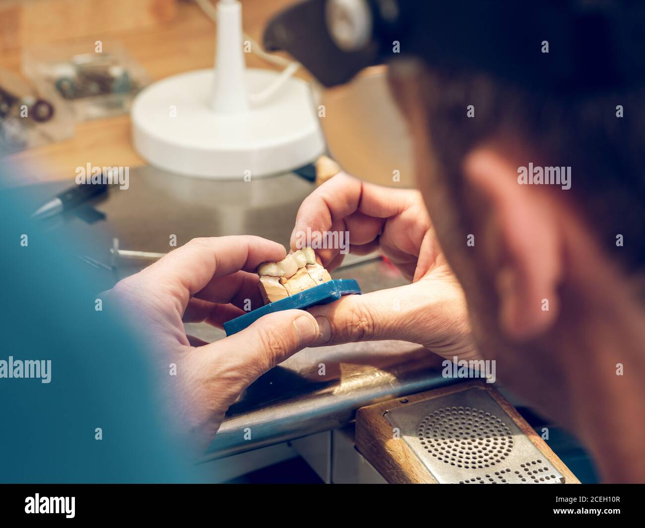 Hands of technician making denture Stock Photo - Alamy