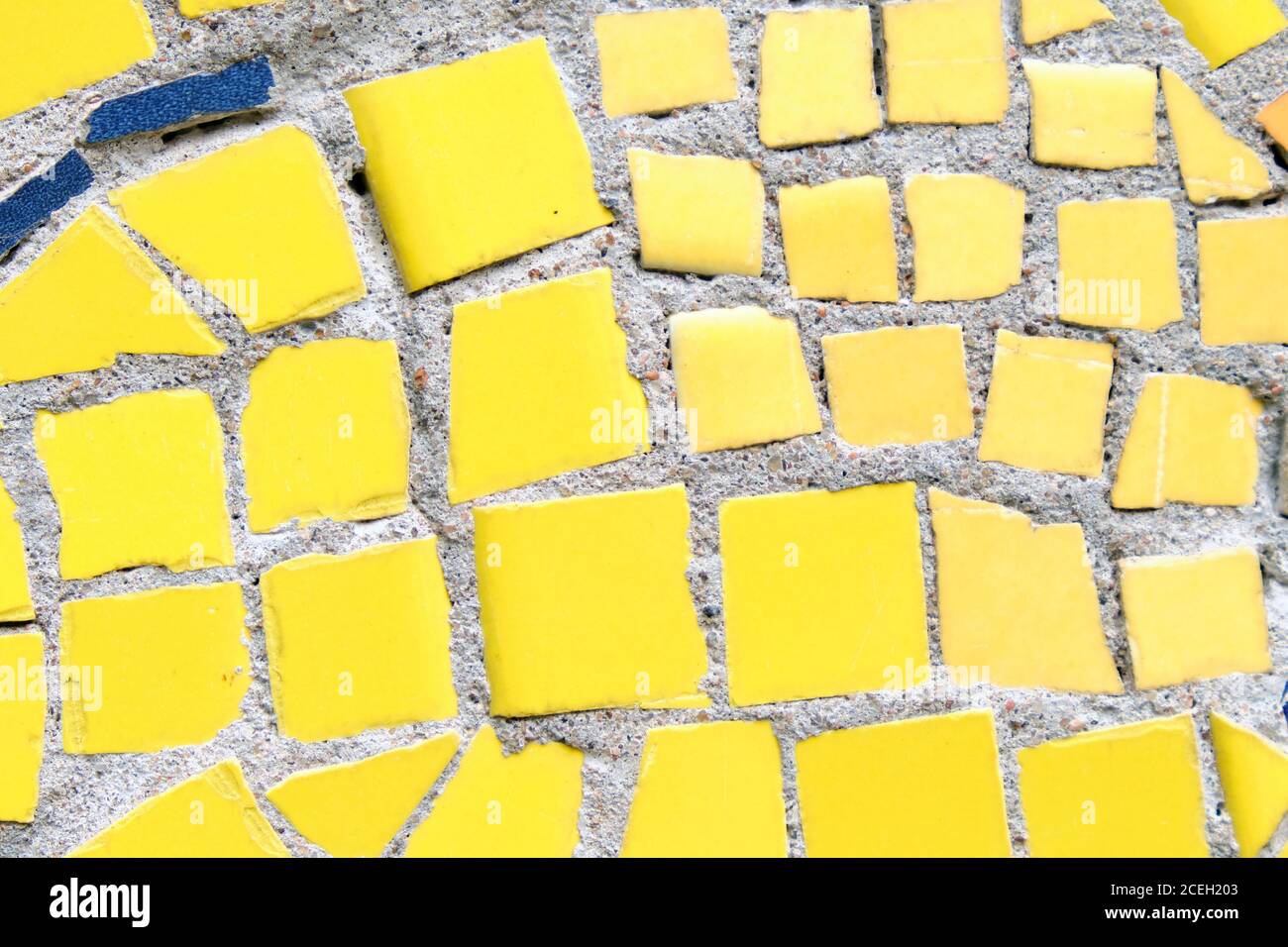 Mosaic of broken yellow small tiles tiles as background Stock Photo - Alamy