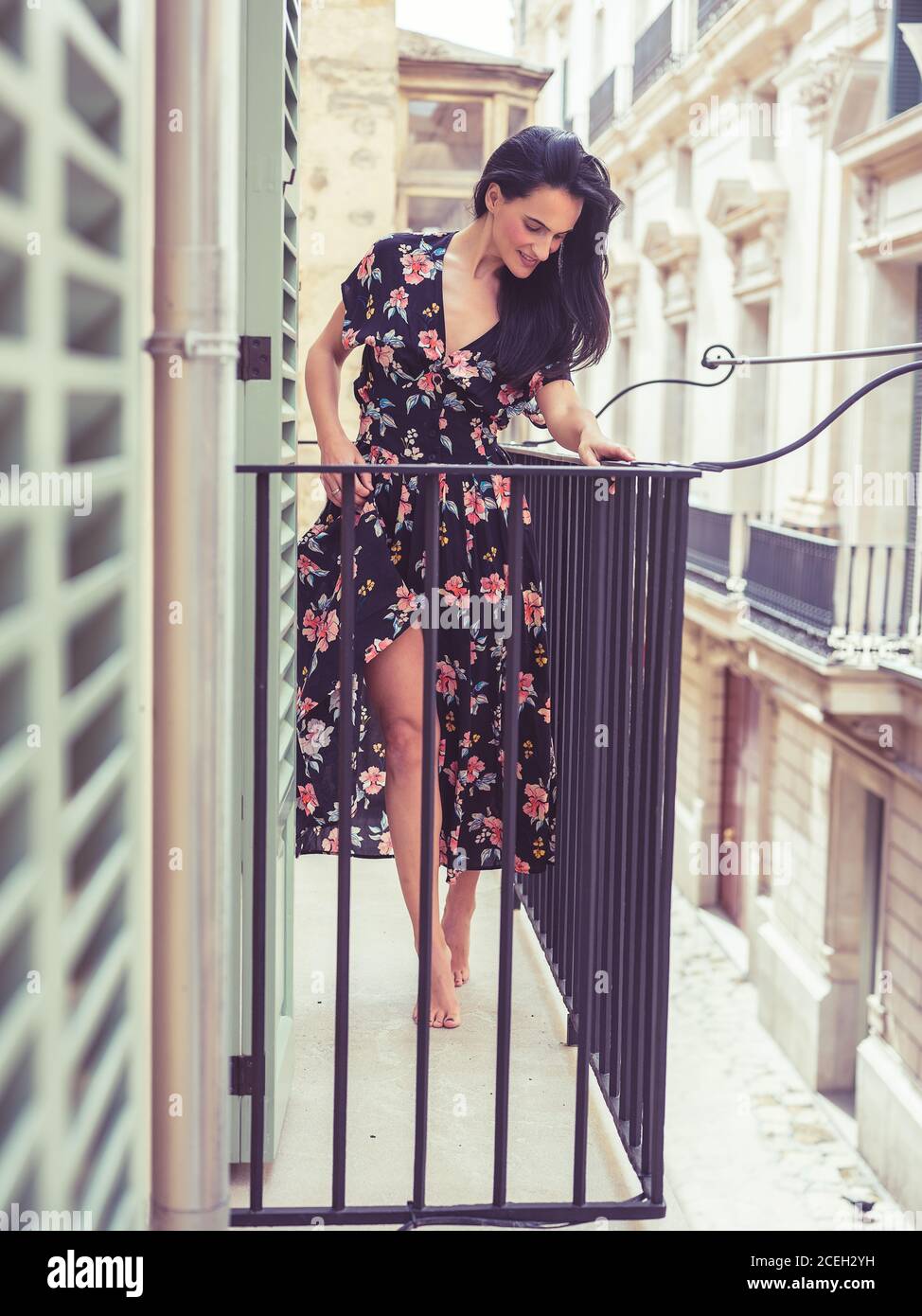 Young woman standing balcony hi-res stock photography and images - Alamy