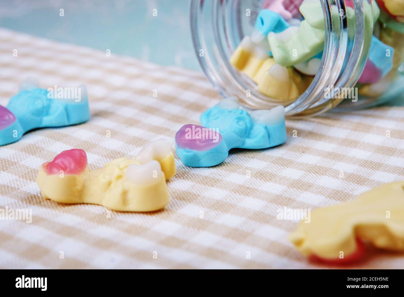colorful neon gummy a cow candies scattered from glass jar Stock Photo ...