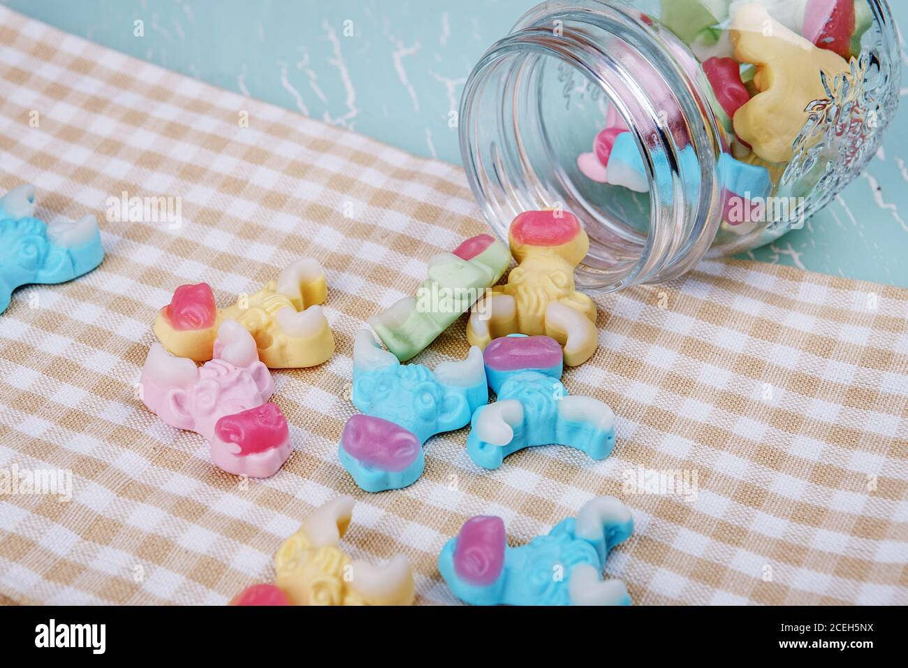 colorful neon gummy a cow candies scattered from glass jar Stock Photo ...