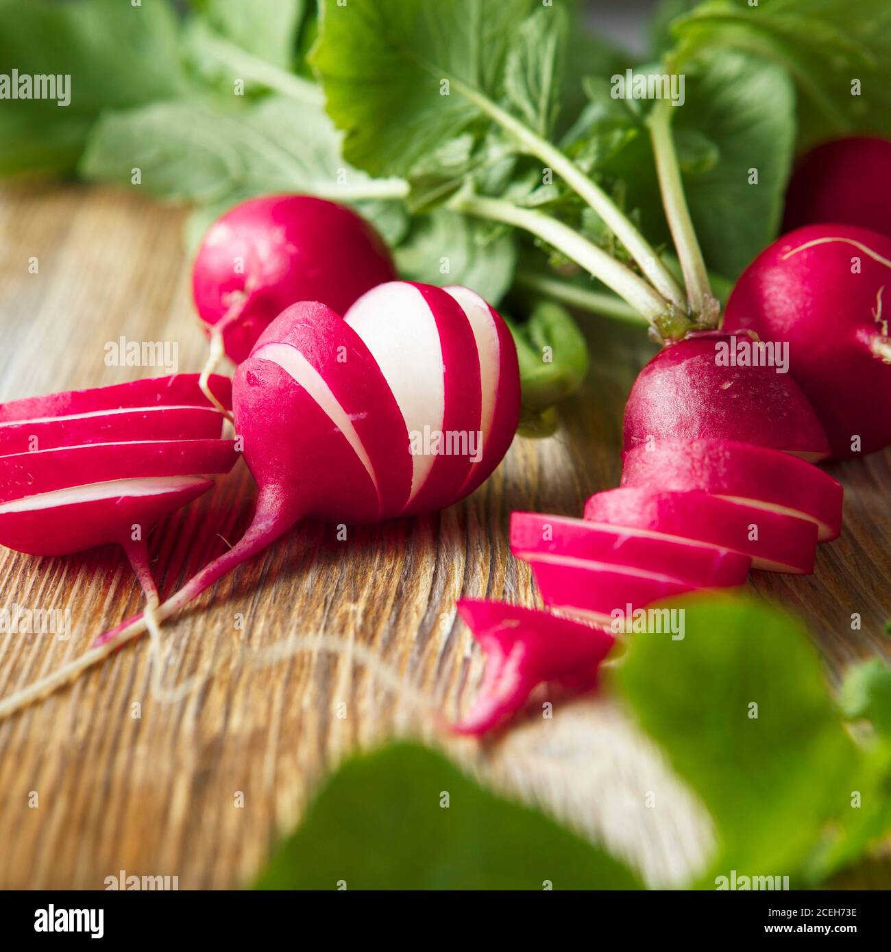 Freshly harvested, purple colorful radish on wooden cutting board ...