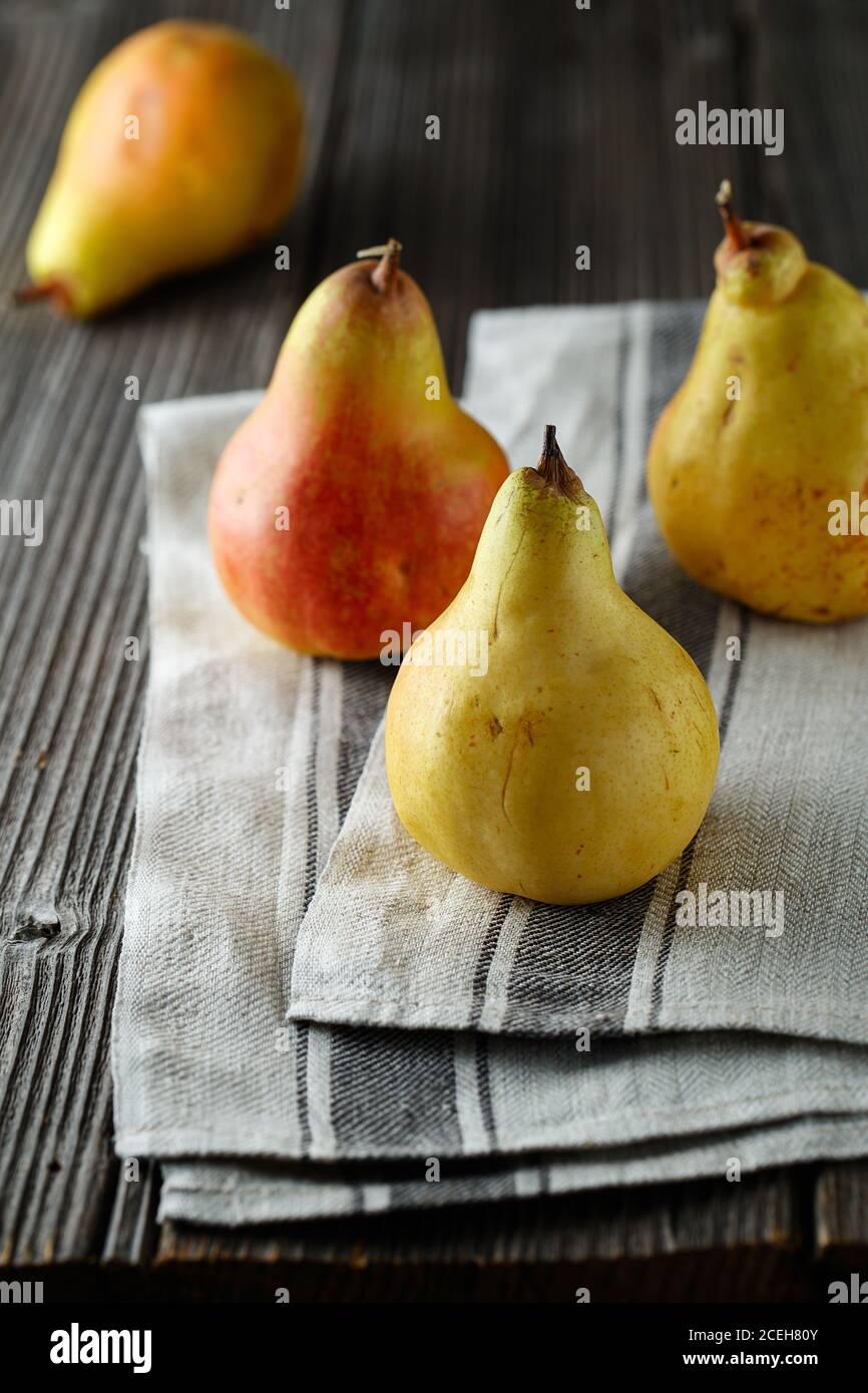 Seasonal fruits. Several tasty ripe juicy pears on a wooden background ...