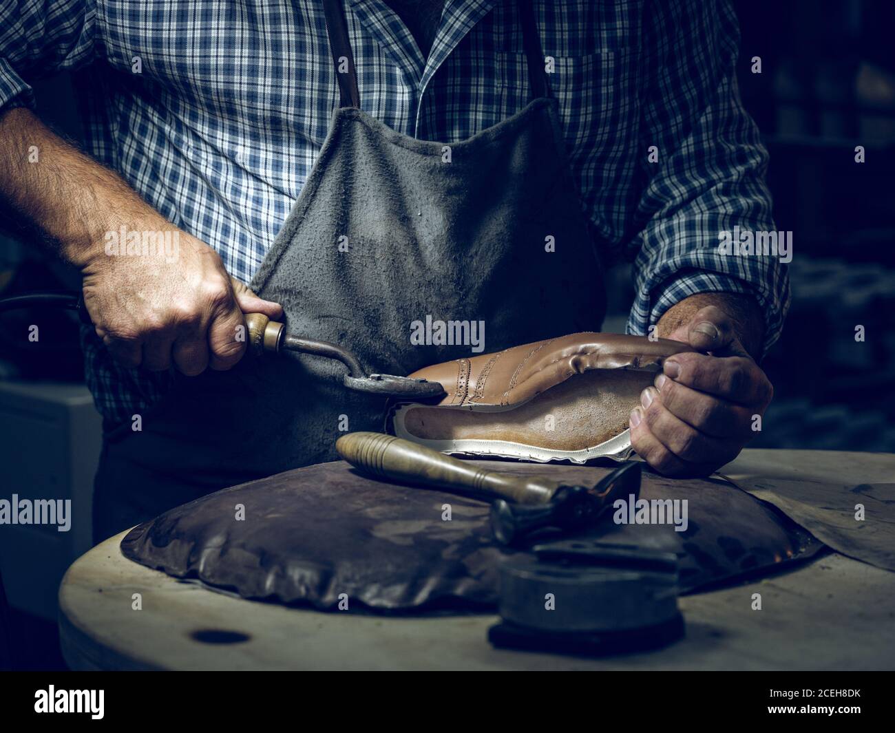 anonymous man making shoes Stock Photo - Alamy