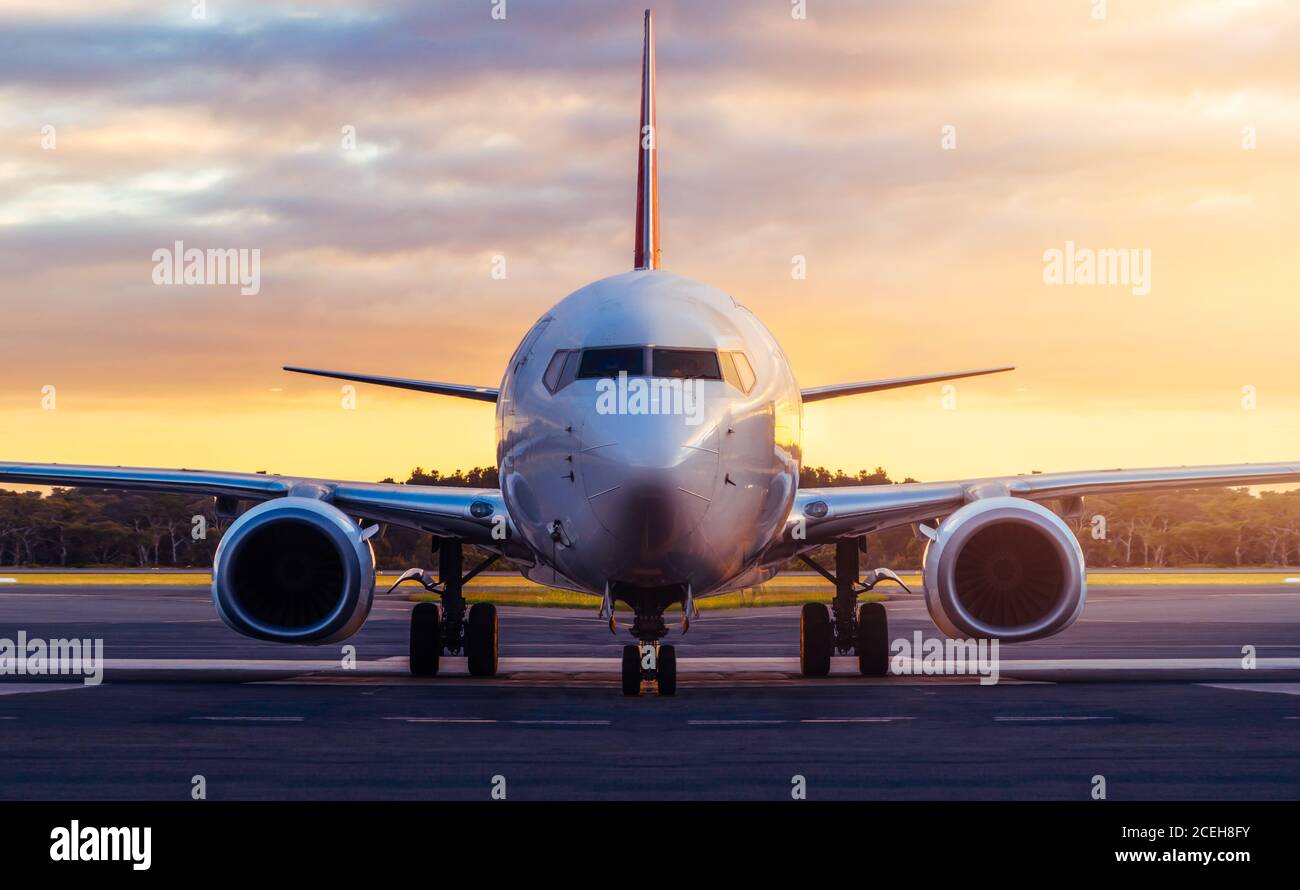 Airplane on airport runway sunset hi-res stock photography and images ...