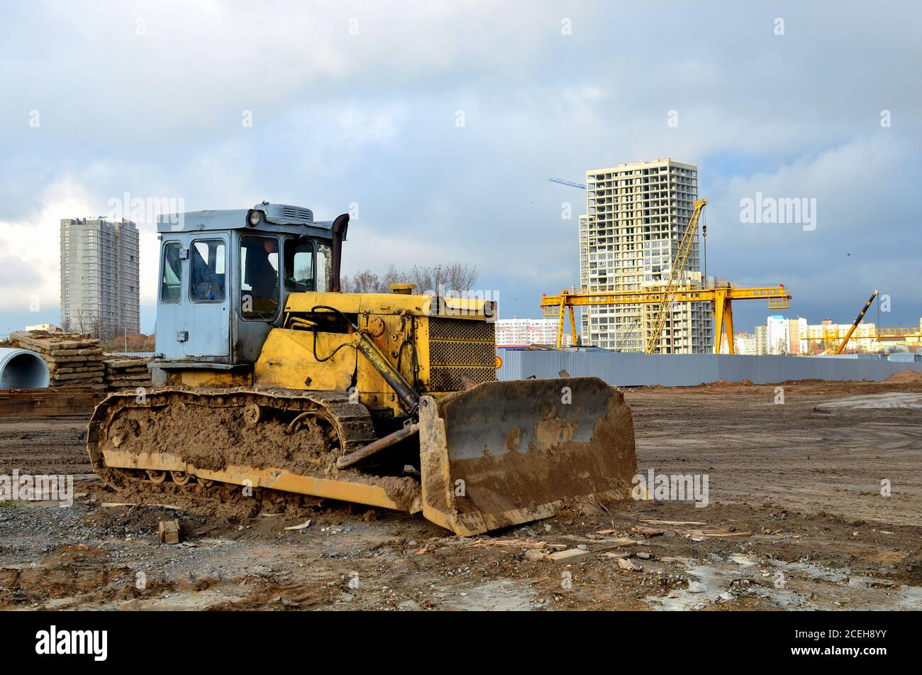 Bulldozer during of large construction jobs at building site. Crawler ...