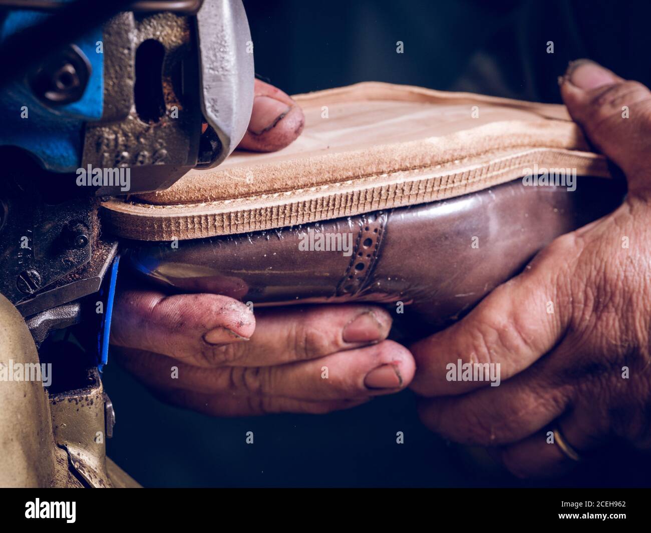 Crop craftsman making shoe on factory Stock Photo - Alamy