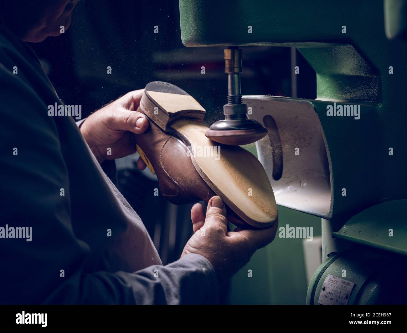 Crop craftsman making shoe on factory Stock Photo - Alamy