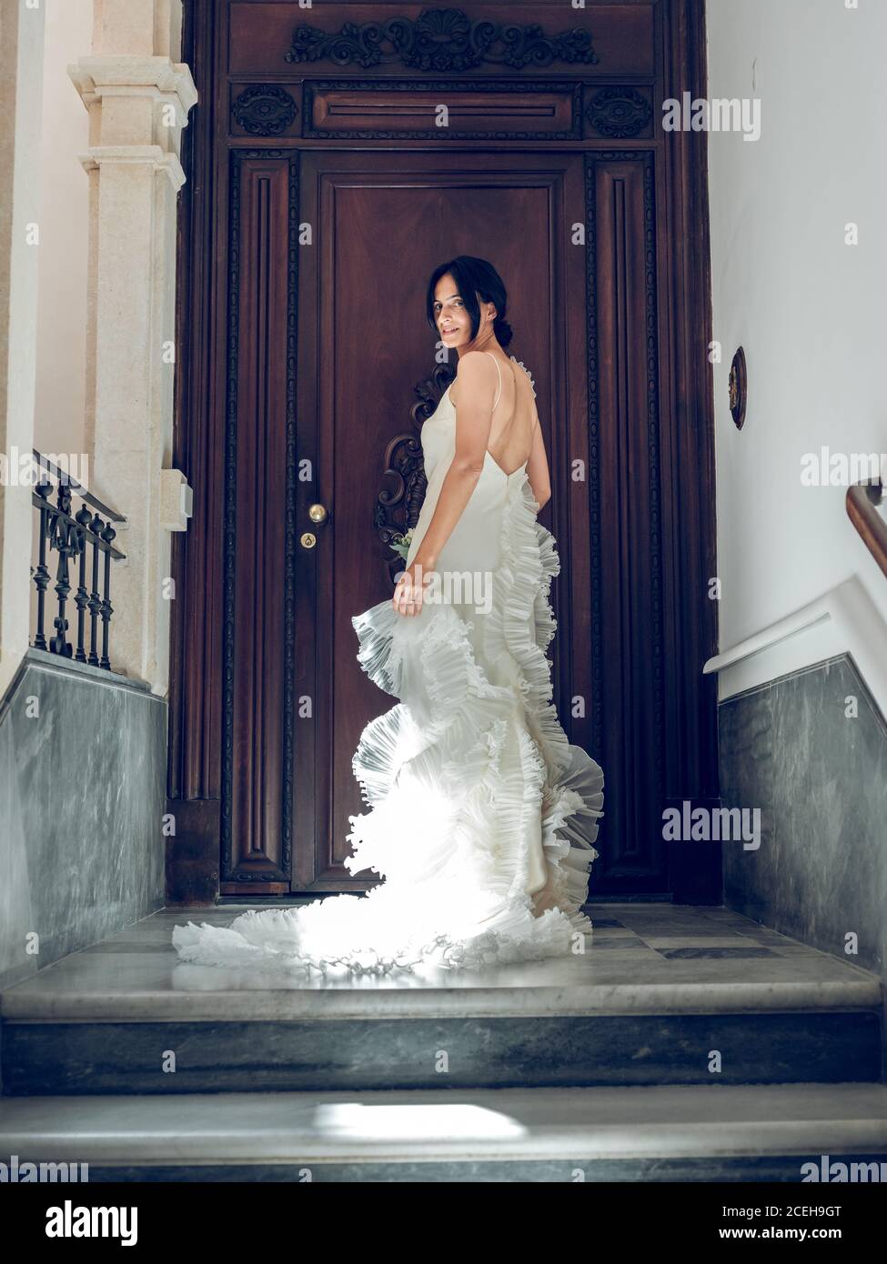 Bride climbing steps Stock Photo - Alamy