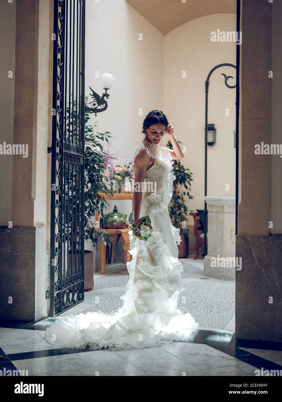 Bride standing in doorway of luxury building Stock Photo - Alamy
