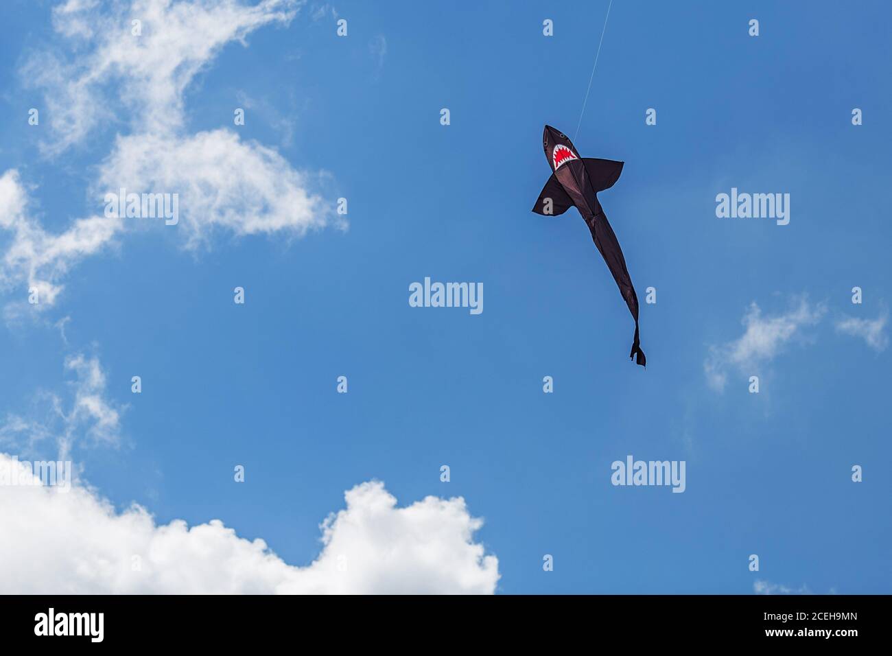 kites flying in a blue sky. Kites of various shapes. kiting Stock Photo ...