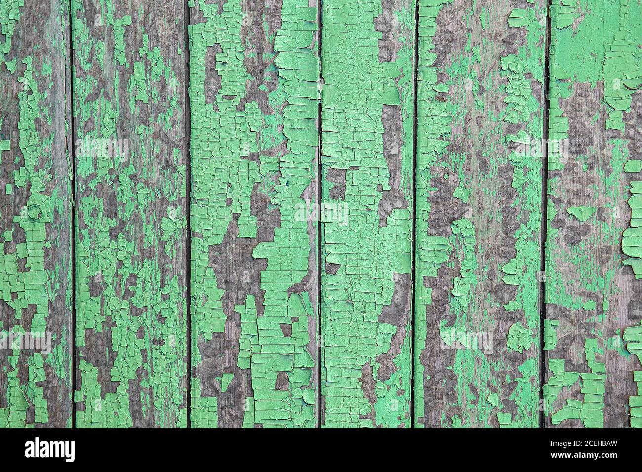 Cracking and peeling green paint on a wall. Vintage wood background ...