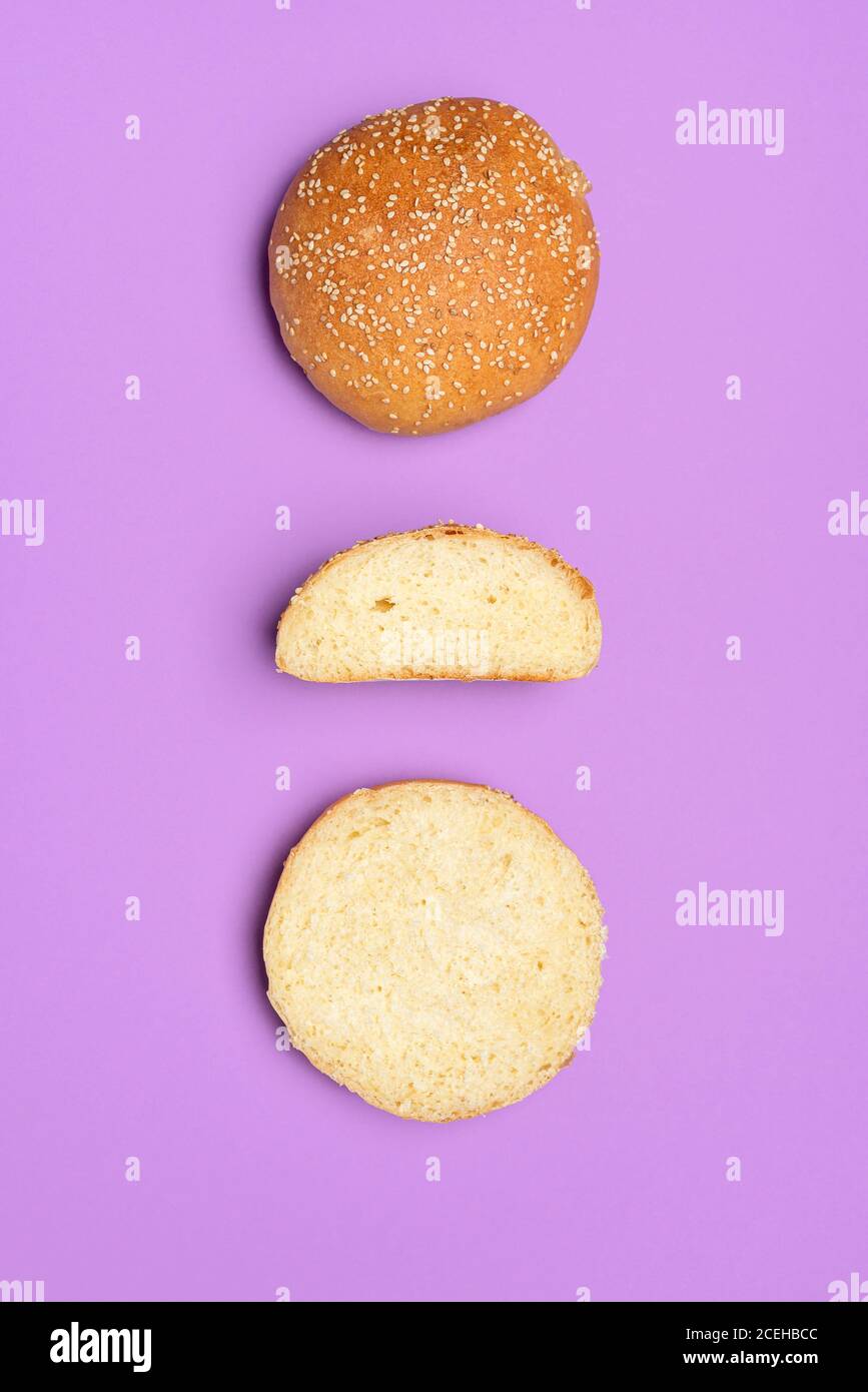 Homemade bread buns section, isolated on a purple background. Flat lay ...