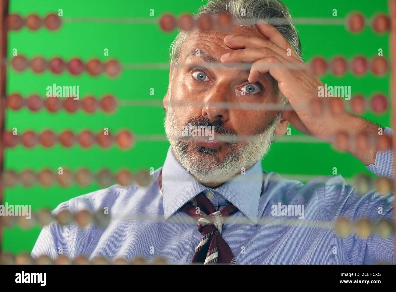 accountant behind an abacus over green background Stock Photo - Alamy