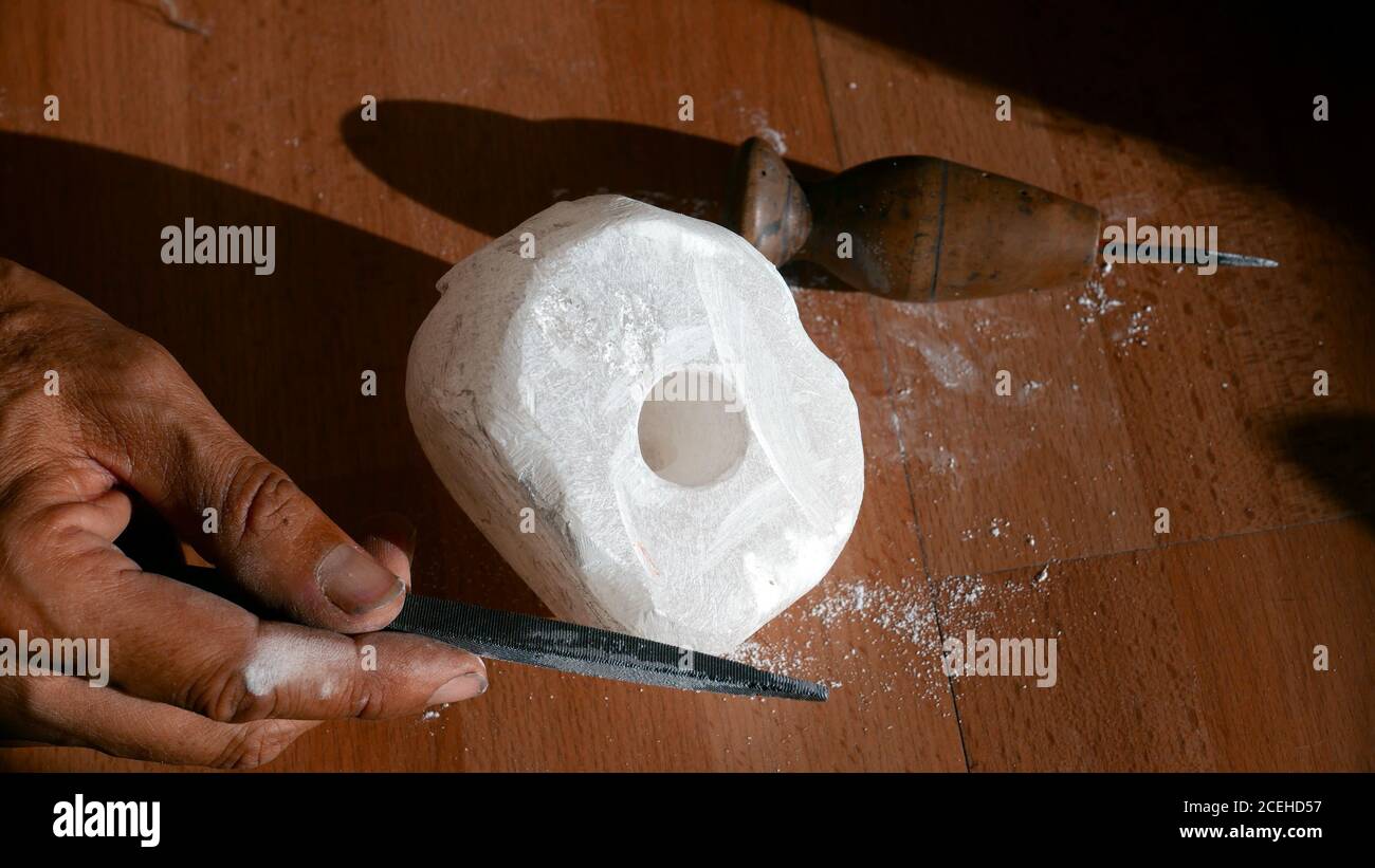 Hand processing stone craftsman with file Stock Photo - Alamy