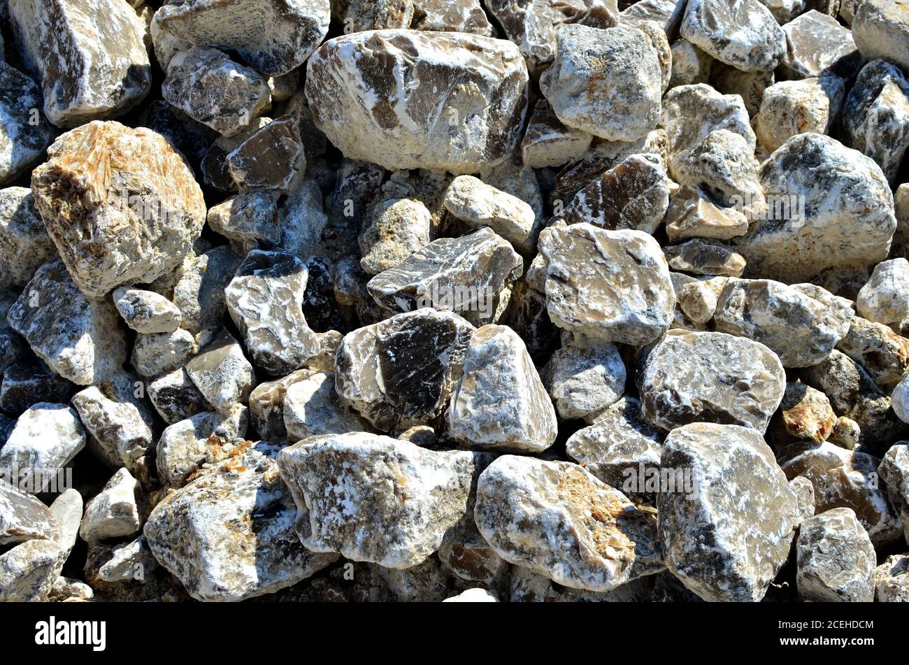 Natural gray gypsum stone. Close up image of stones with black and ...