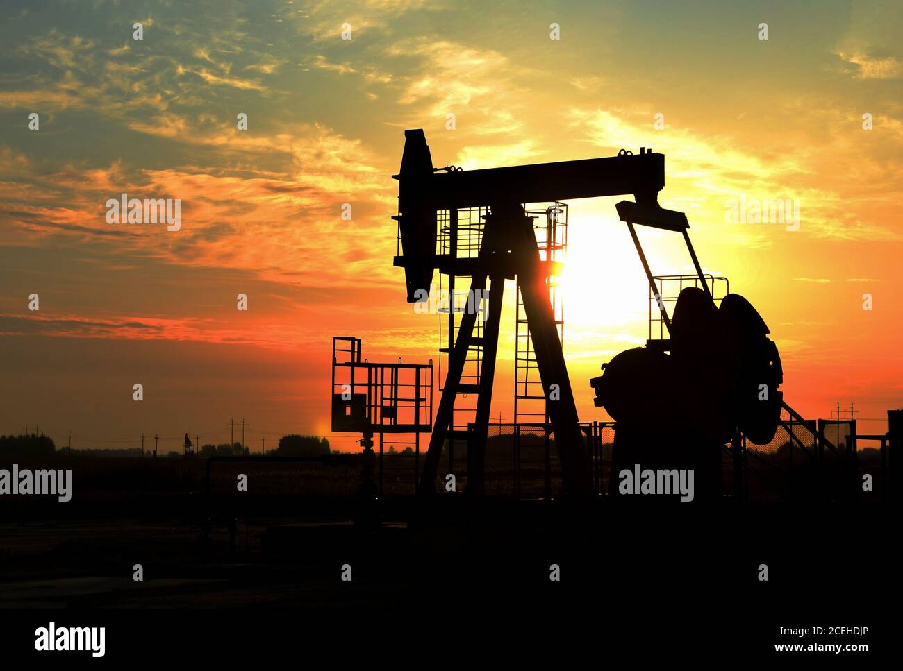 Oil drilling derricks at desert oilfield for fossil fuels output and ...
