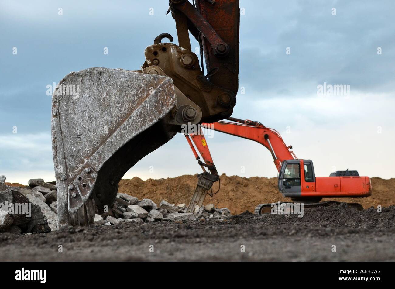 Excavator working in a construction site. Large metal iron ladle ...