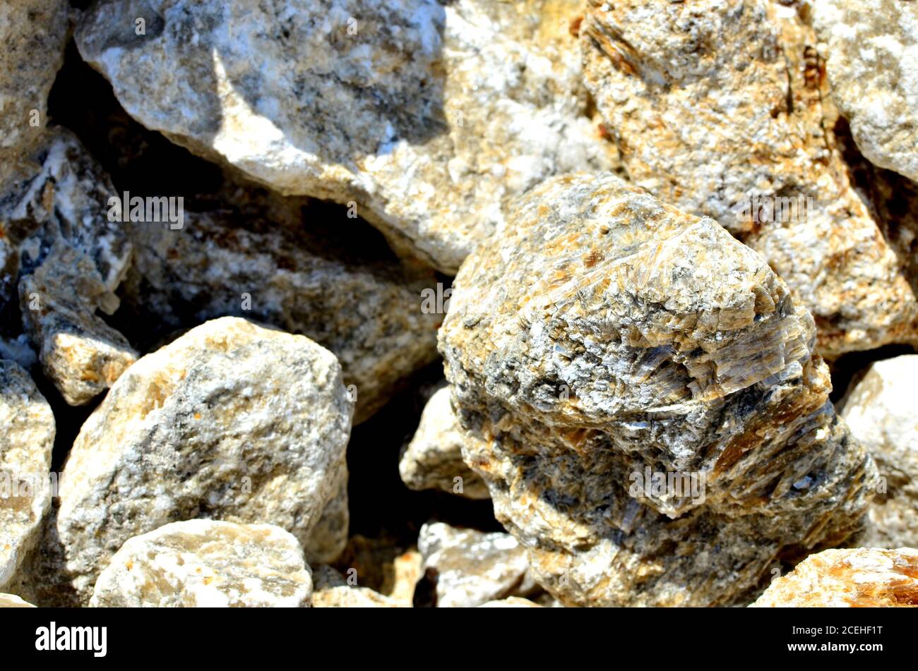 Natural gray gypsum stone. Close up image of stones with black and ...