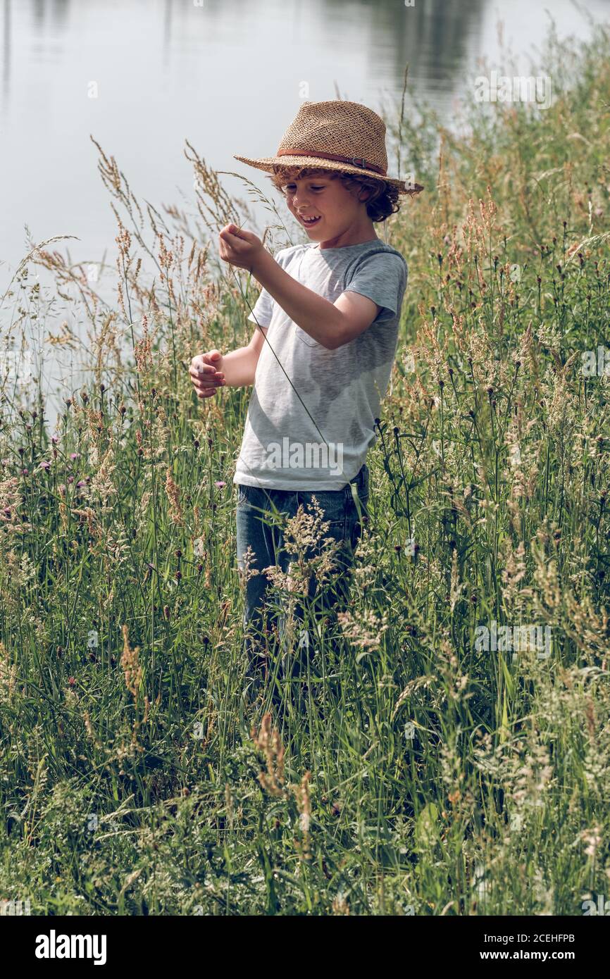 Little boy standing near water Stock Photo - Alamy